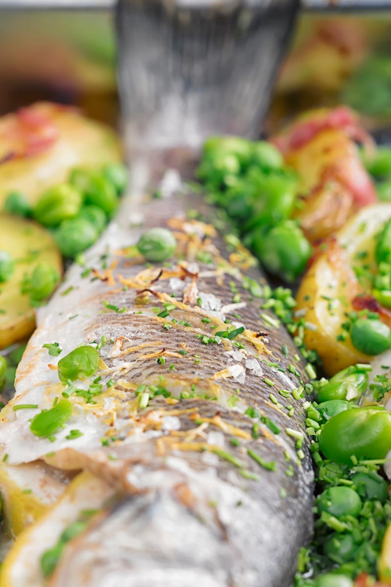 Whole Baked Sea Bass With Potatoes Broad Beans And Peas Krumpli